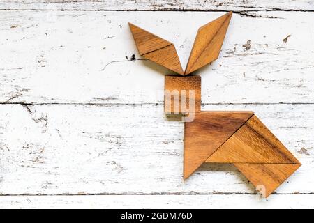 Tangram puzzle in rabbit shape on old white wood background Stock Photo ...