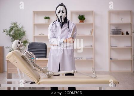 Devil doctor examining skeleton patient in the clinic Stock Photo - Alamy