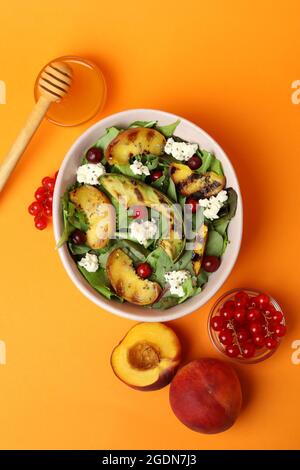 Plate of salad with grilled peach on white wooden table Stock Photo - Alamy