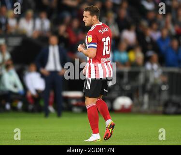 SWANSEA, UK. AUG 14TH Billy Sharp of Sheffield United disputes the ...