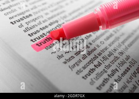 Pink marker highlighting word in dictionary Stock Photo - Alamy