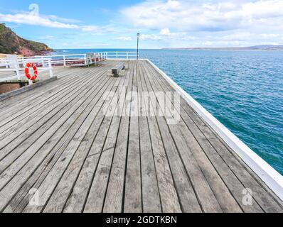 Historic Tathra Wharf is a popular fishing spot as seen from the beach ...