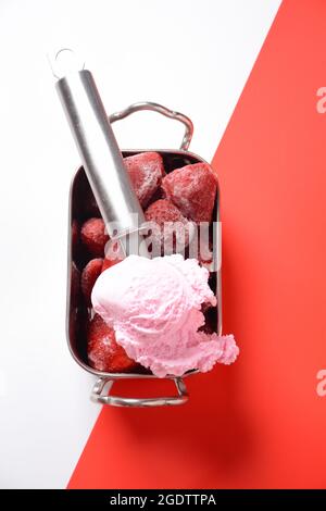 Frozen strawberries in silver bowl on white and red Stock Photo - Alamy