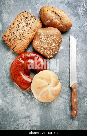 Assorted buns on grey stone background. Breakfast time Stock Photo - Alamy
