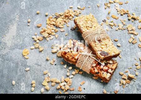 Two muesli bars on grey stone background. Healthy food Stock Photo - Alamy