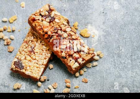 Two muesli bars on grey stone background. Healthy food Stock Photo - Alamy