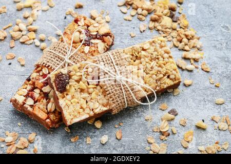 Two muesli bars on grey stone background. Healthy food Stock Photo - Alamy