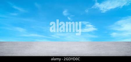 Panoramic empty grunge cement counter table top on blue sky white light ...