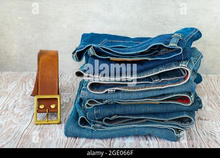Denim pants stack on wood shelf Stock Photo - Alamy