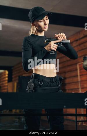 Female concentrated on pulling her gun slide to the rear Stock Photo ...
