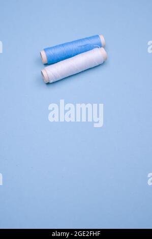 Vertical closeup of threads on the aesthetic blue background Stock ...