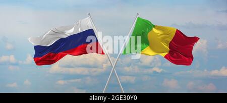 Russia and Mali two flags on flagpoles and blue cloudy sky Stock Photo ...