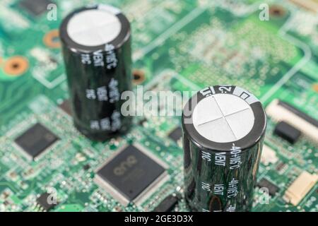 Close-up shot of aluminium electrolytic capacitor on pcb, showing ...