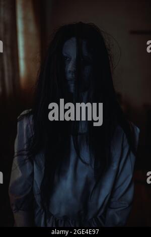 Zombie girl with long hair in her face in an abandoned building Stock ...