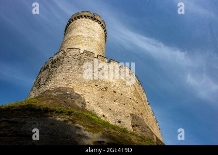 A circular stone tower behind the walls with the battlements of a ...