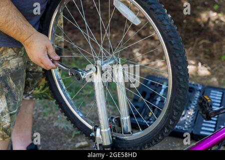 Man repairing bicycles in a handsome bike mechanic Stock Photo - Alamy