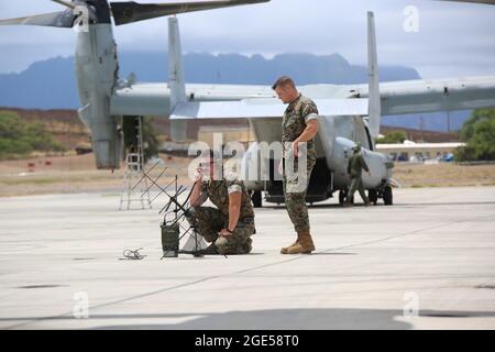 Marine Corps Systems Command Sgt. Maj. Allen Goodyear, left, looks on ...