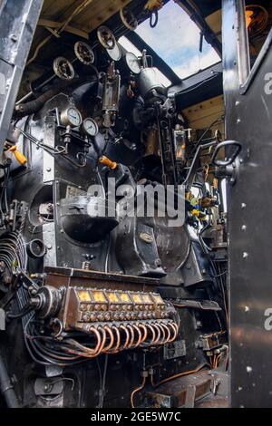 Driver's cab of an old steam locomotive with the modern train control ...