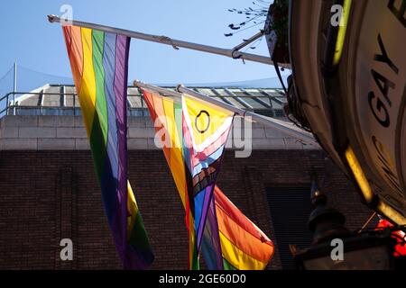 LGBT flag in Soho,London. People walking in Soho London,Brewer street ...