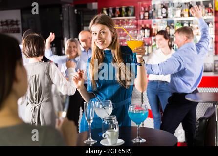 Girl drinking cocktail and dancing Stock Photo - Alamy