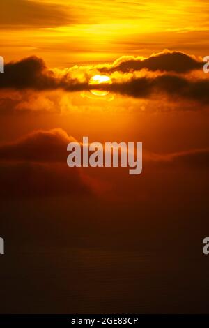 Sunset behind clouds, near Moonlight Tops Hut, Paparoa Track, (one of ...