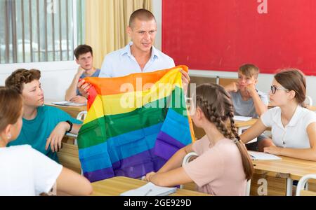School teacher with flag explains to students what is LGBT Stock Photo ...