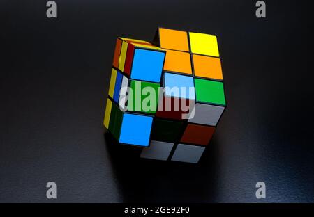 Colorful rubik cube with long shadow on rough dark background Stock ...