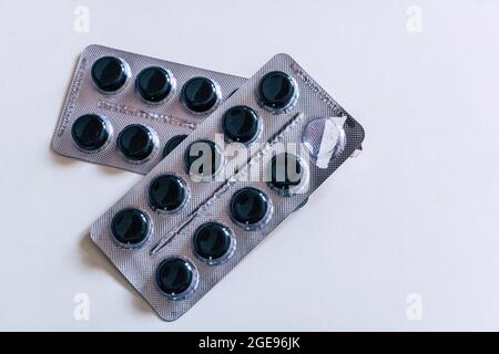 Diarrhea black coal pills Stock Photo - Alamy