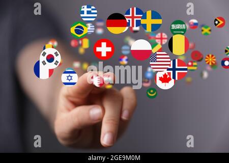 Hand selecting from icons of different country flags Stock Photo - Alamy