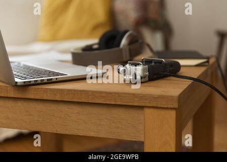 Modern audio recorder placed on wooden table on background of blurred ...