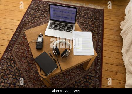 Modern audio recorder placed on wooden table on background of blurred ...
