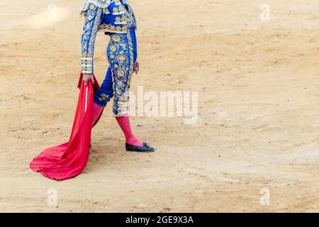 Crop unrecognizable bullfighter in traditional red costume and with ...