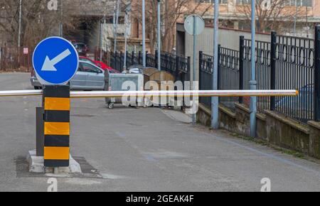 Parking Ramp Barrier Boom and Direction Arrow Sign Stock Photo - Alamy