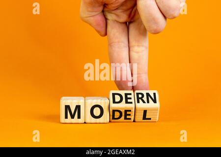 Modern model symbol. Businessman turns wooden cubes and changes the ...
