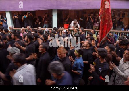 Shia Muslims beat chests as they walk during Ashura procession. Ashura ...