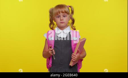 Joyful funny schoolgirl making humorous face with eyes crossed, playing ...