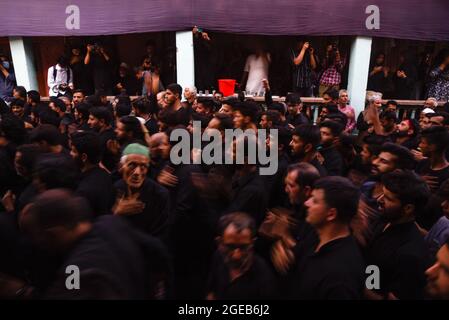 Shia Muslims beat chests as they walk during Ashura procession. Ashura ...