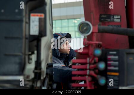 The driver of the hydraulic manipulator in the workplace Stock Photo ...
