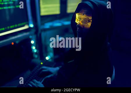 Cyber hacker breaks into databases to obtain information using a computer. Cybercrime and data ...