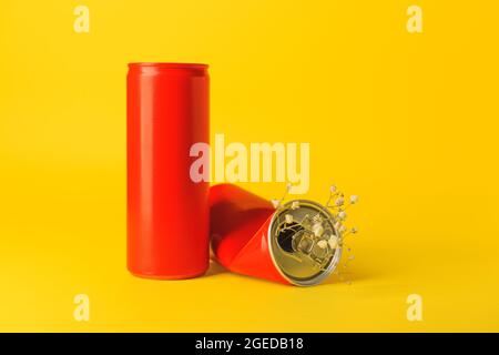 Cans of soda and flowers on color background Stock Photo - Alamy