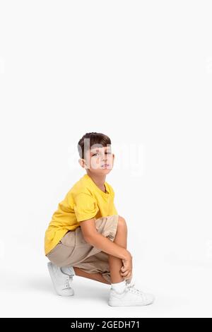 Little boy scratching himself on white background Stock Photo - Alamy