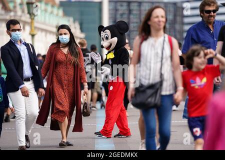 A person dressed as Mickey Mouse on Westminster Bridge, London. Picture ...