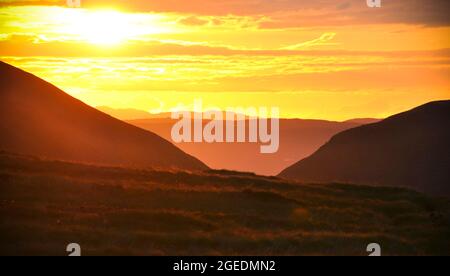 Sunset over the mountains of the Isle of Arran, Scotland Stock Photo ...