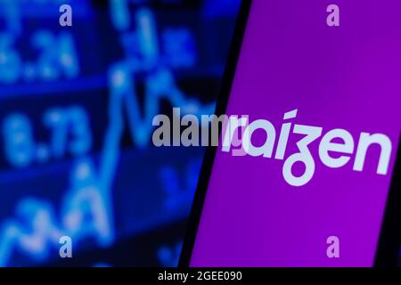 In this photo illustration the Raízen logo seen displayed on a ...