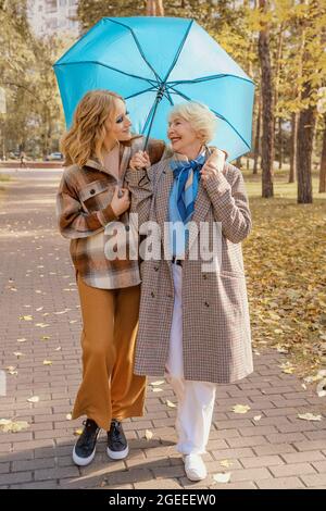 Hello september. happy young woman in beige coat with autumn yellow ...