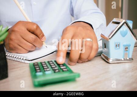 Closeup of a Hispanic businessman's hands as he uses a computer mouse ...