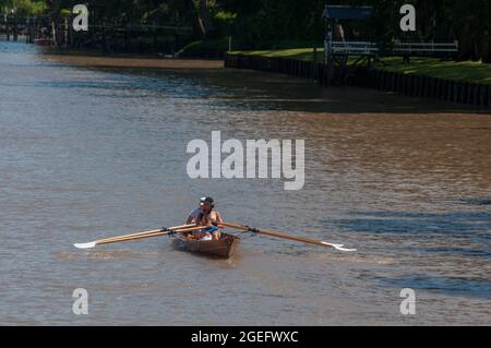 TIGRE, ARGENTINA - Nov 12, 2010: A pair of women rowing in the brown ...