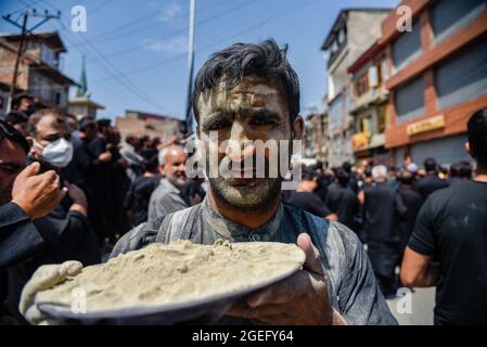 A Kashmiri Shia Muslim man smeared with mud taken from the soil of the ...