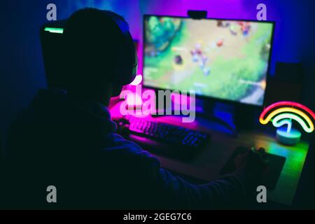 Streamer gamer playing at strategy game online - Focus on right hand ...