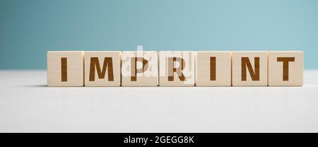 The word imprint built from letters on wooden cubes. High angle view ...